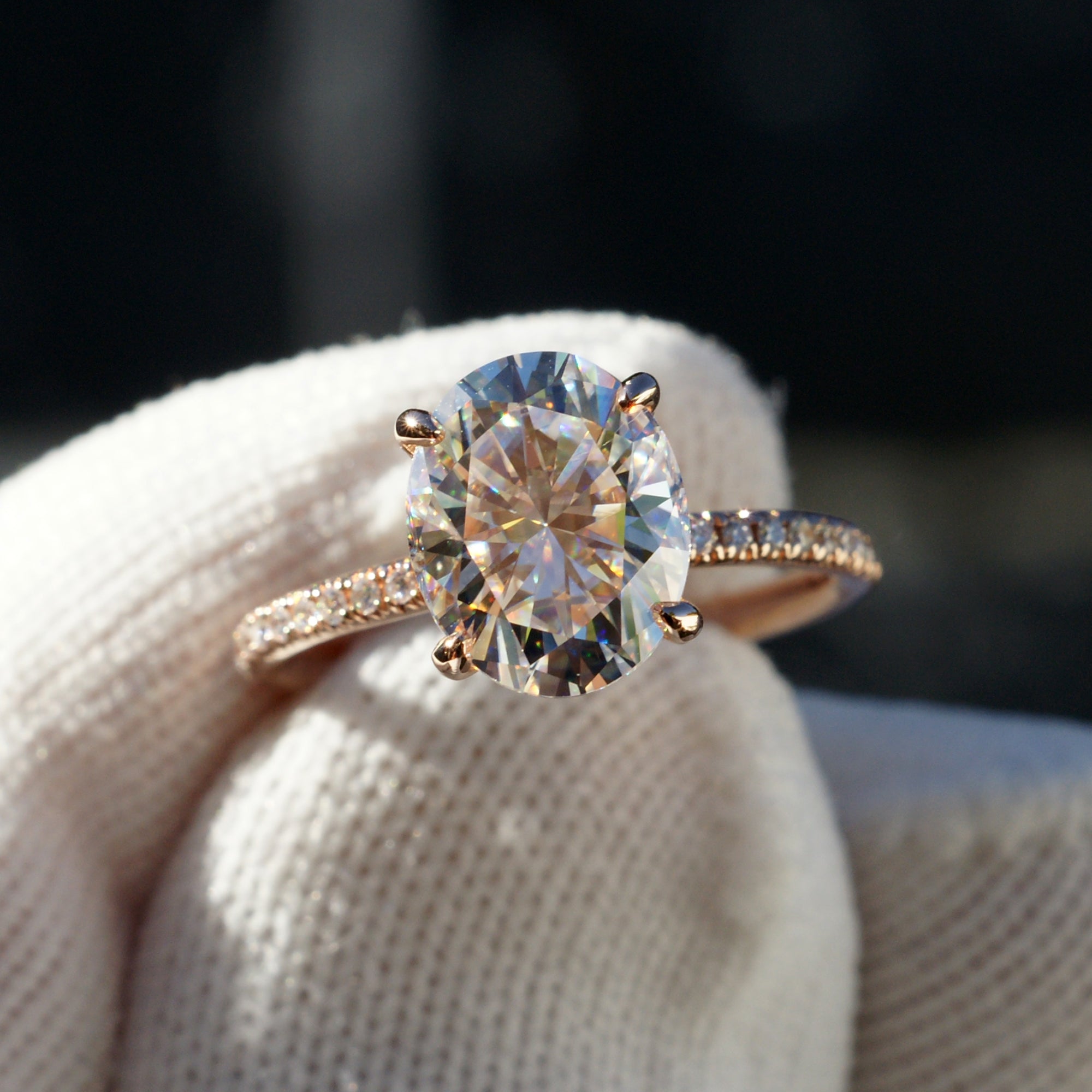Oval moissanite engagement ring with pave diamond band and hidden halo ...